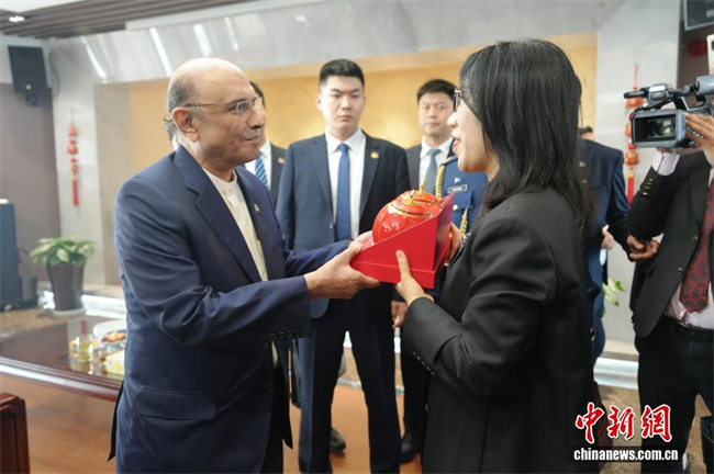 the photo shows staff presenting chinese tea to pakistani president ...